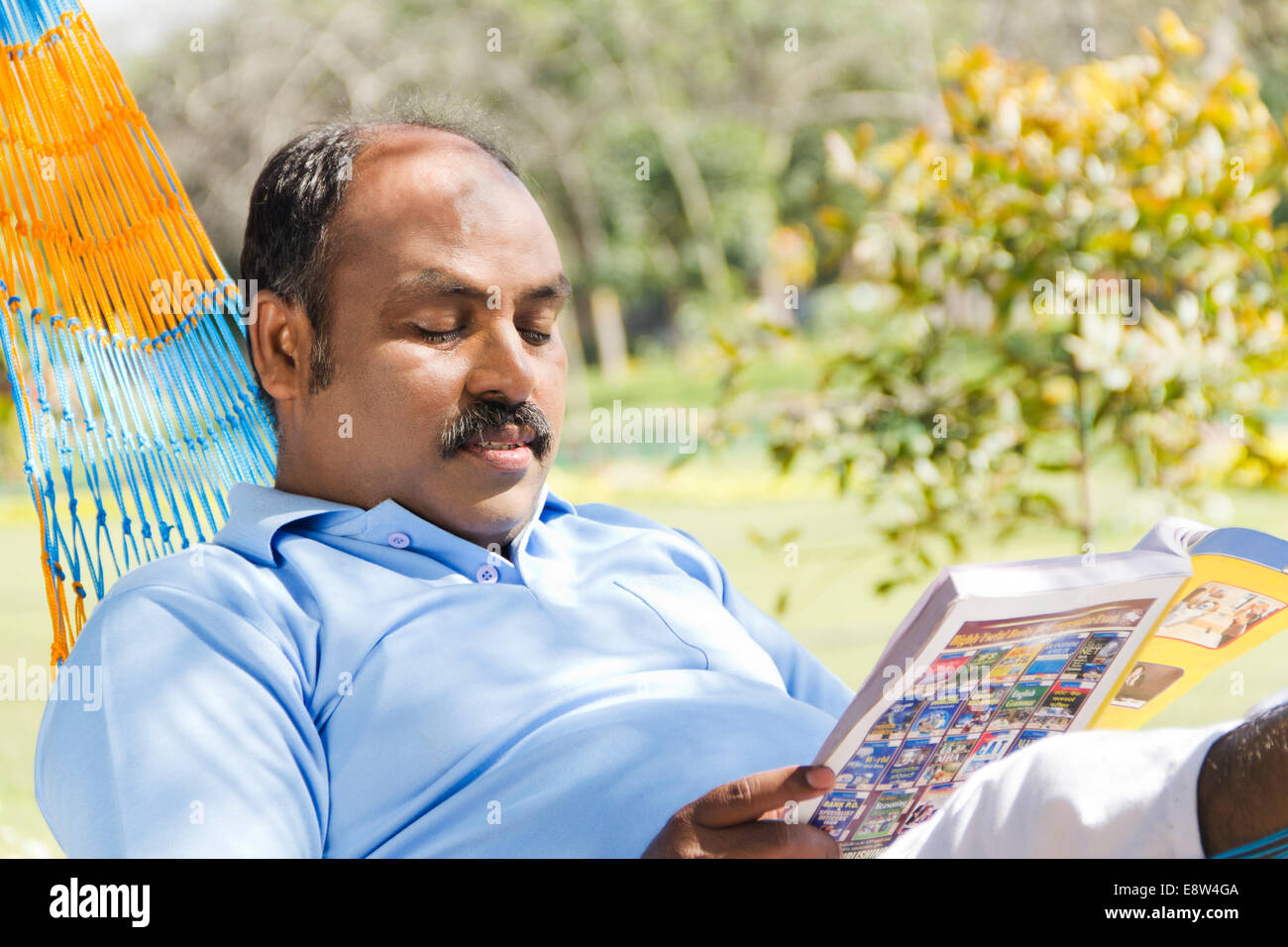 1 Indian an Reading Book In Park Stock Photo - Alamy