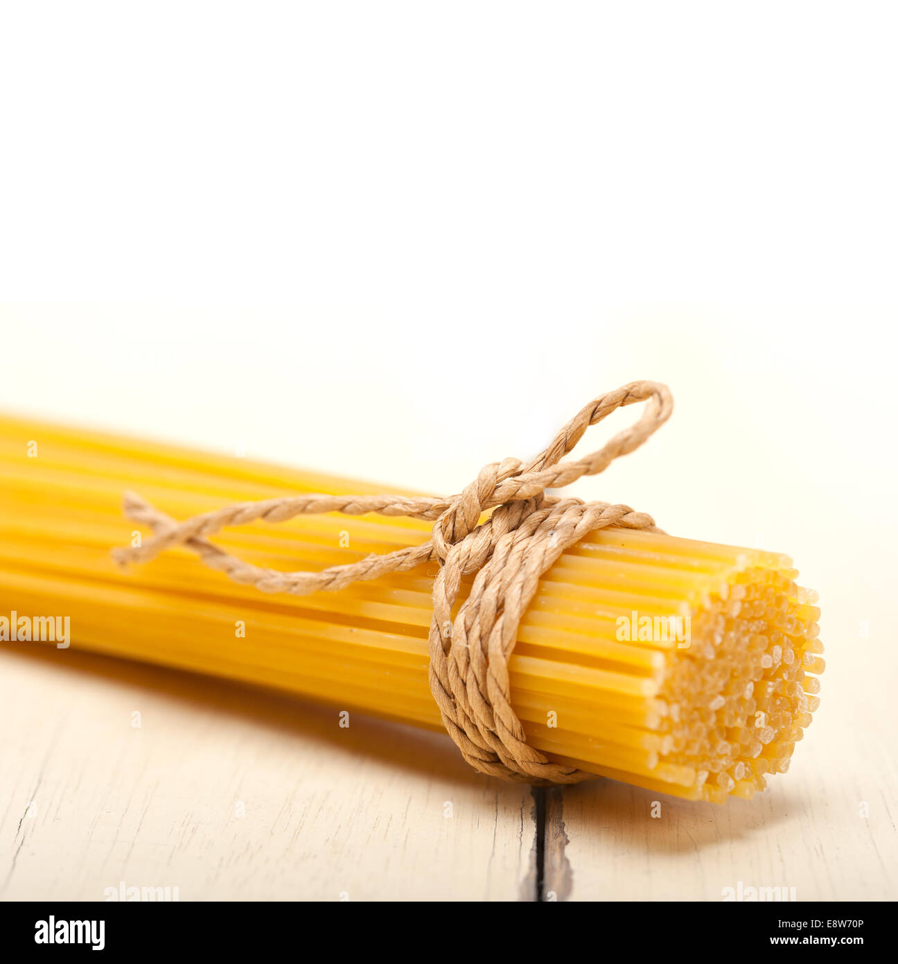 Italian pasta spaghetti tied with a rope on a rustic table Stock Photo ...