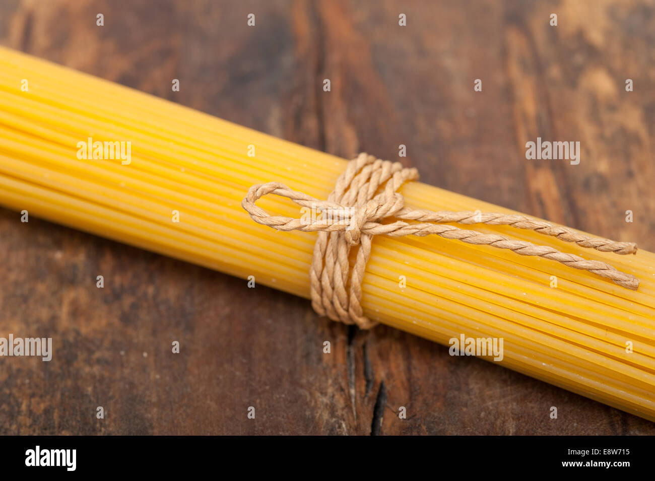 Italian pasta spaghetti tied with a rope on a rustic table Stock Photo ...