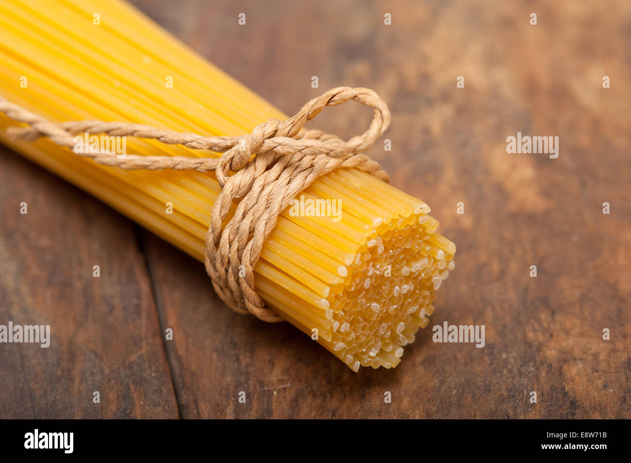 Italian pasta spaghetti tied with a rope on a rustic table Stock Photo ...