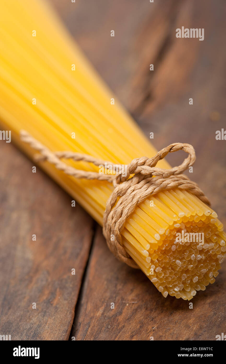 Italian pasta spaghetti tied with a rope on a rustic table Stock Photo ...