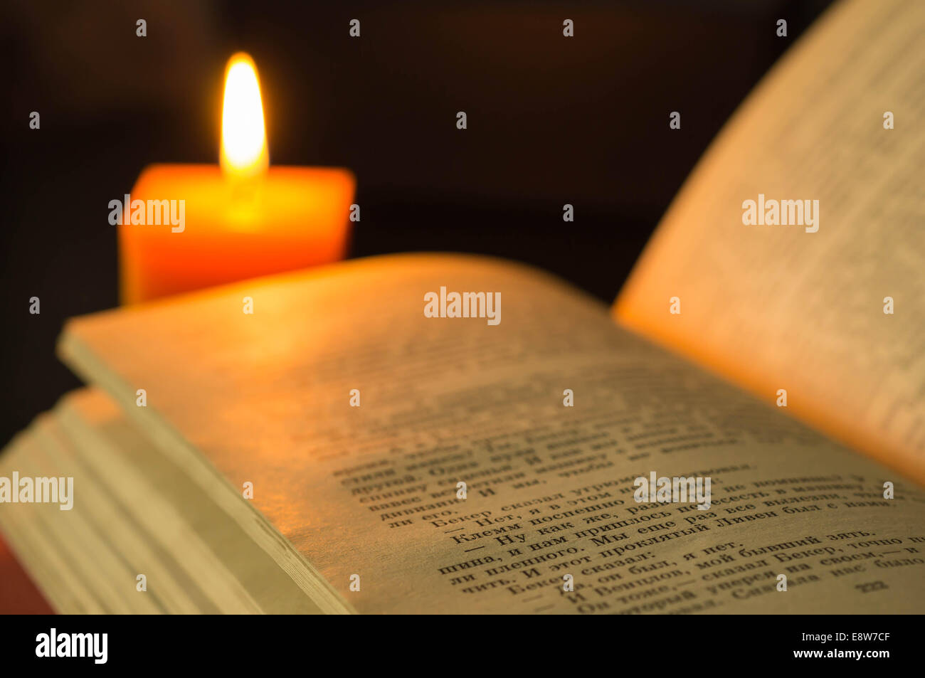 Open book and candle Stock Photo - Alamy