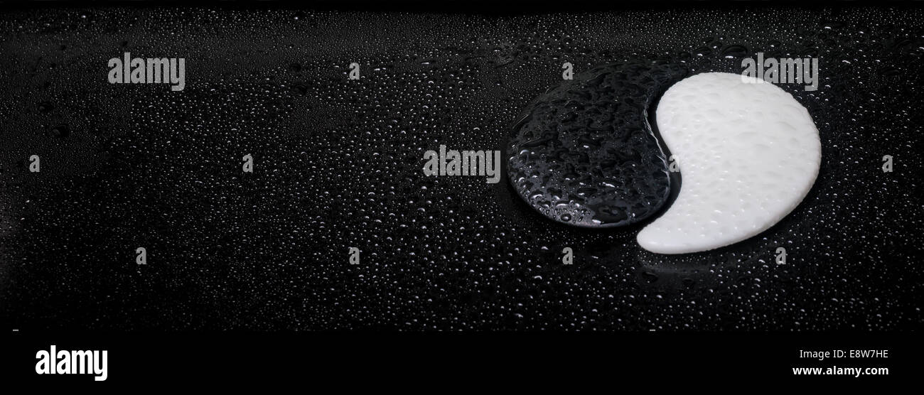 beautiful spa still life of symbol Yin Yang basalt stones with dew ...