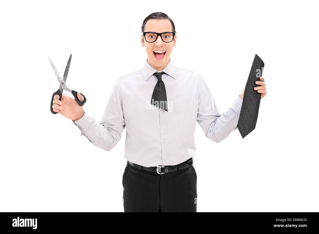 An overjoyed man with a cut tie holding scissors isolated on white ...