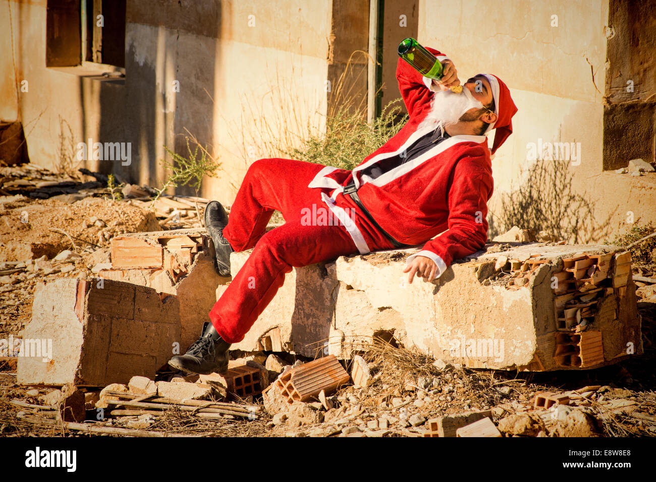 A stressed out Santa indulging in a bottle of champagne Stock Photo - Alamy
