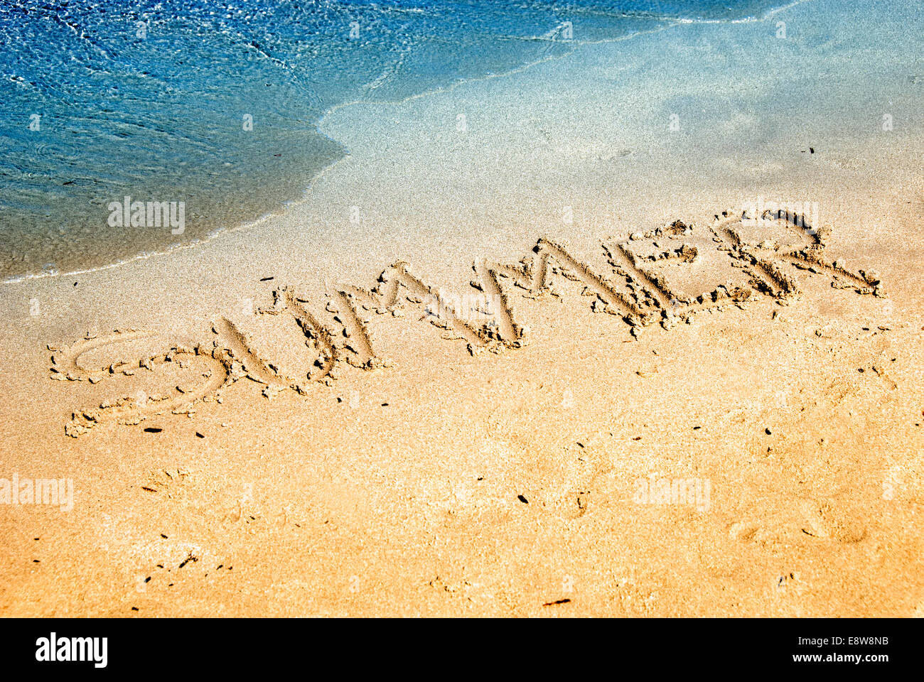 The word summer written in the sand on a beach Stock Photo - Alamy