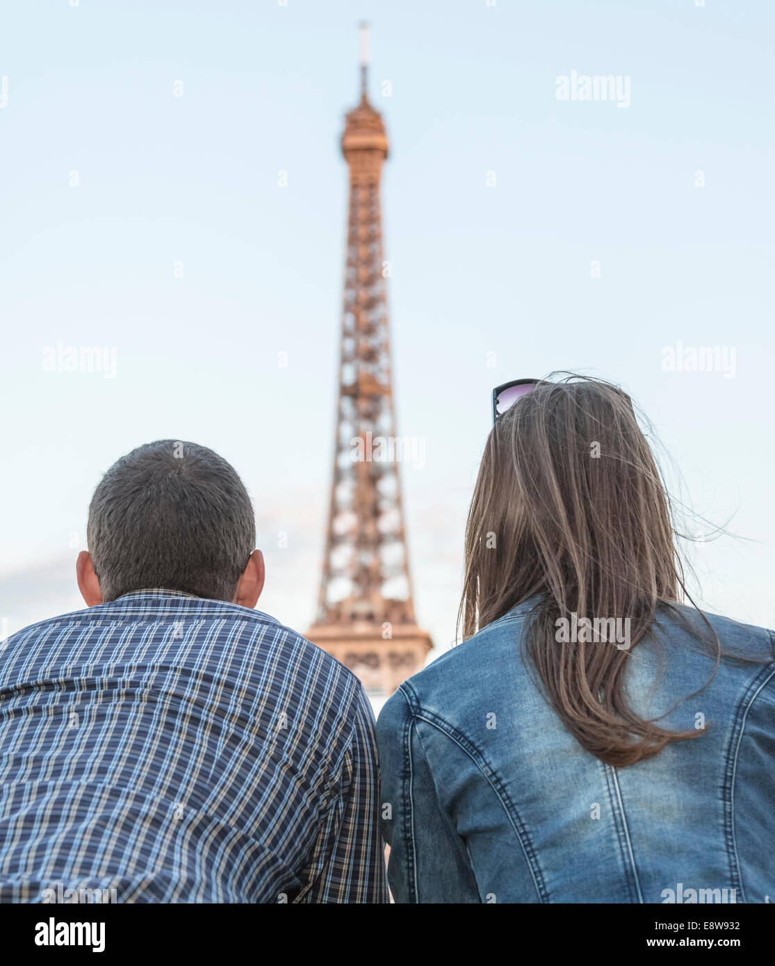 Rear view of a young couple looking to the Eiffel Tower in Paris Stock ...