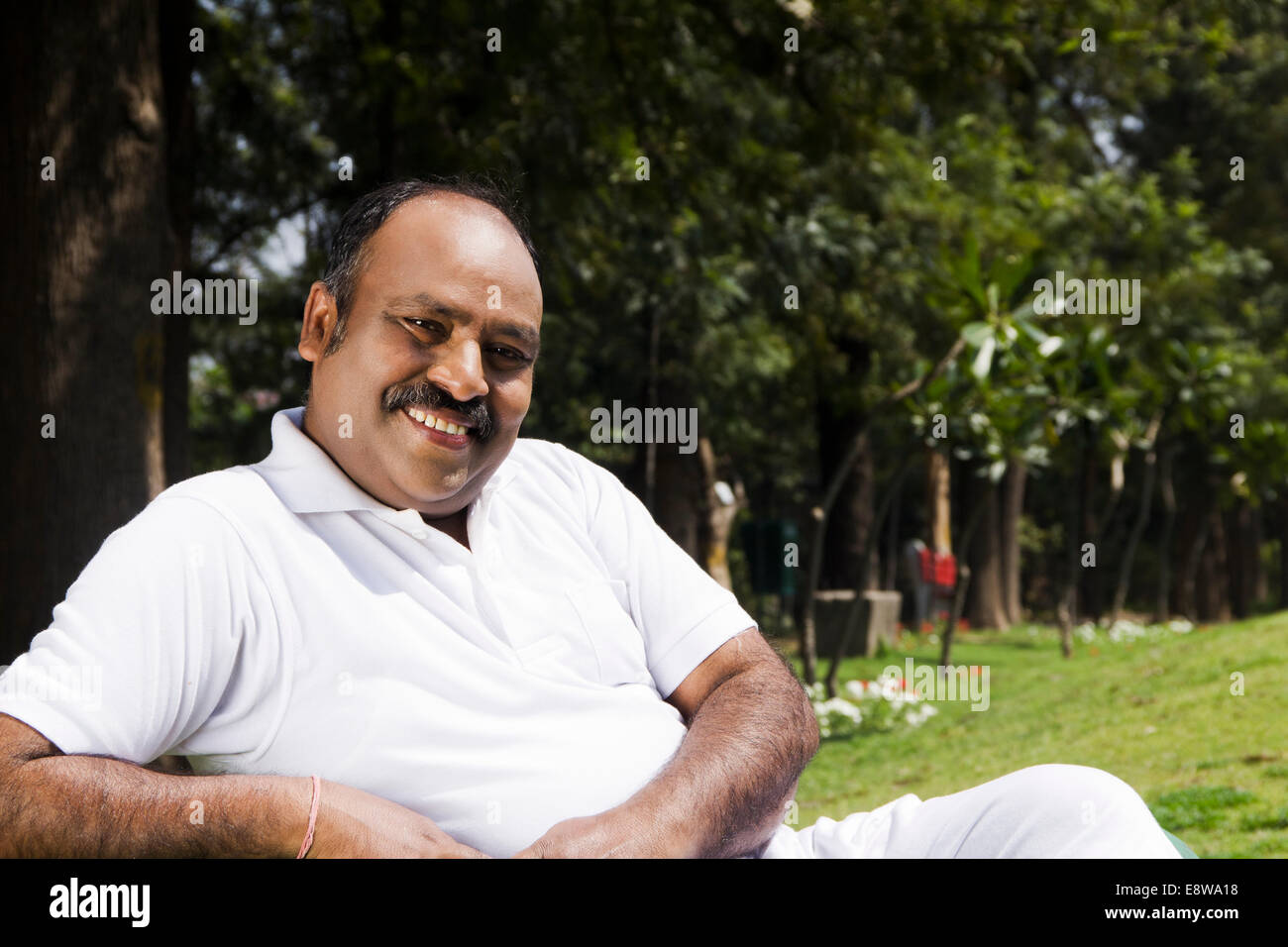 Person sitting on bench in urban garden hi-res stock photography and ...