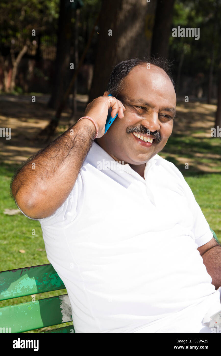 1 Indian Man Talking with Mobile in park Stock Photo - Alamy