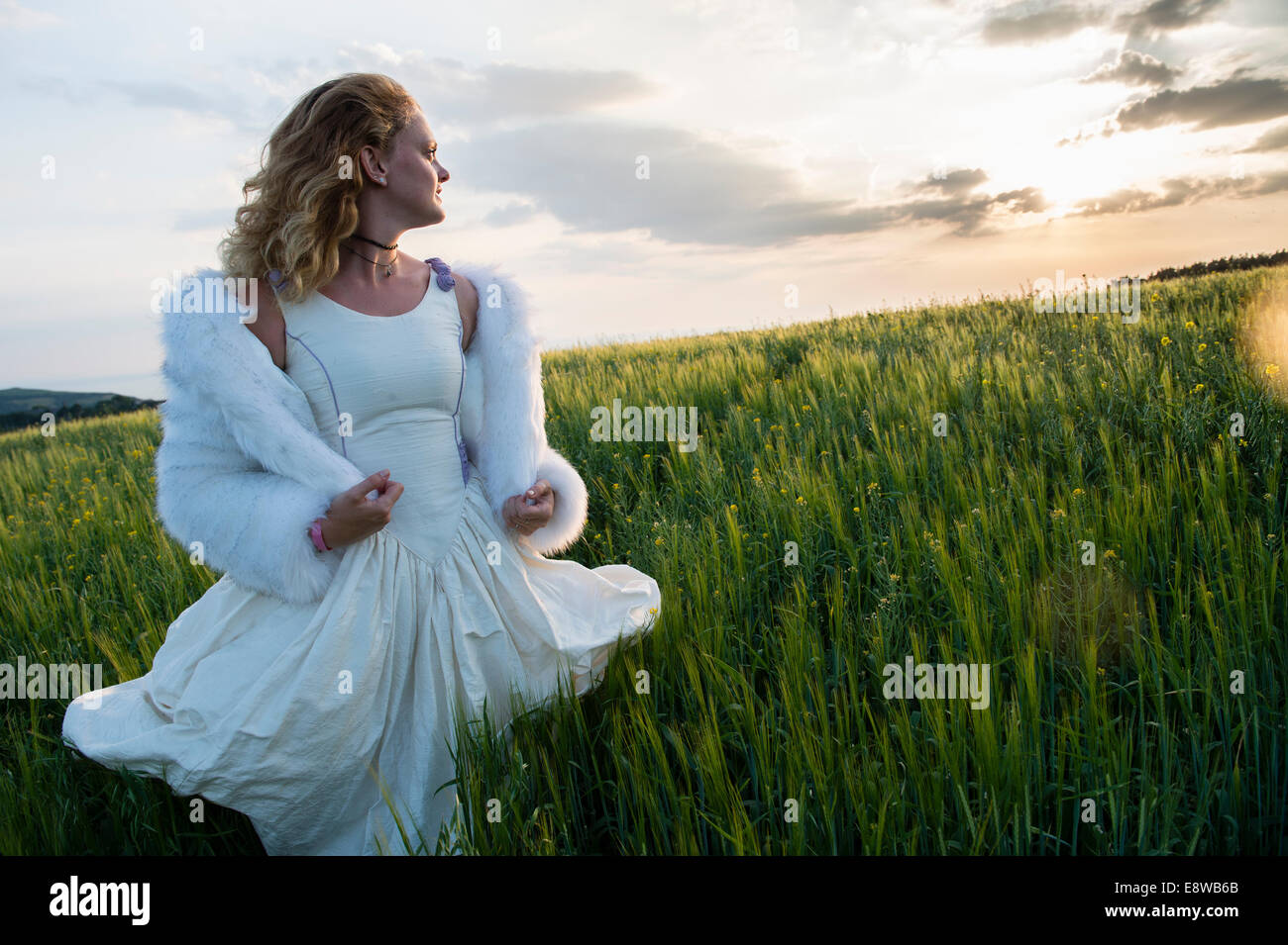 The runaway bride - a young woman girl in a wedding dress standing ...