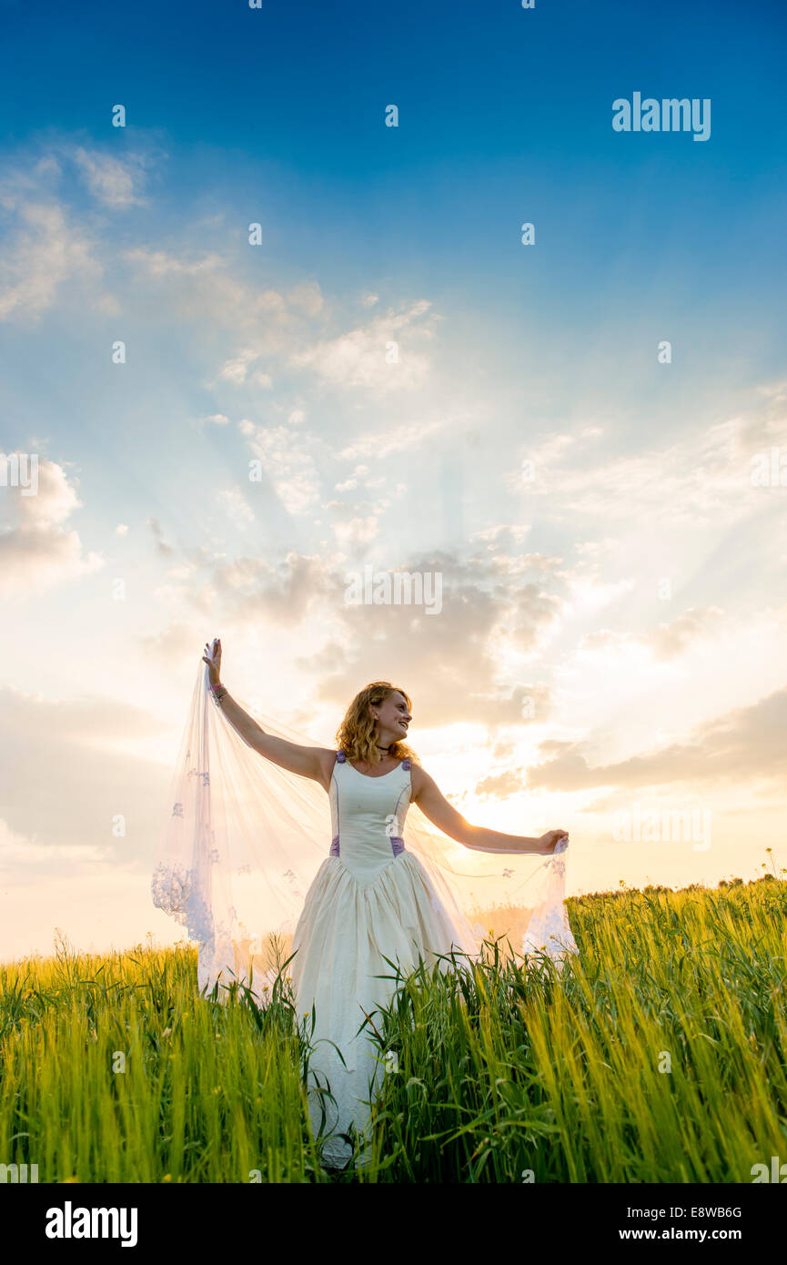 The runaway bride - a happy young woman girl in a wedding dress ...