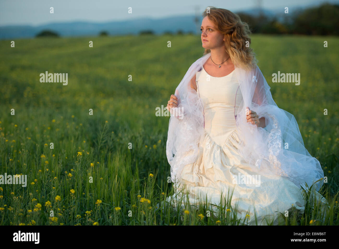 The runaway bride - a young woman girl in a wedding dress standing ...