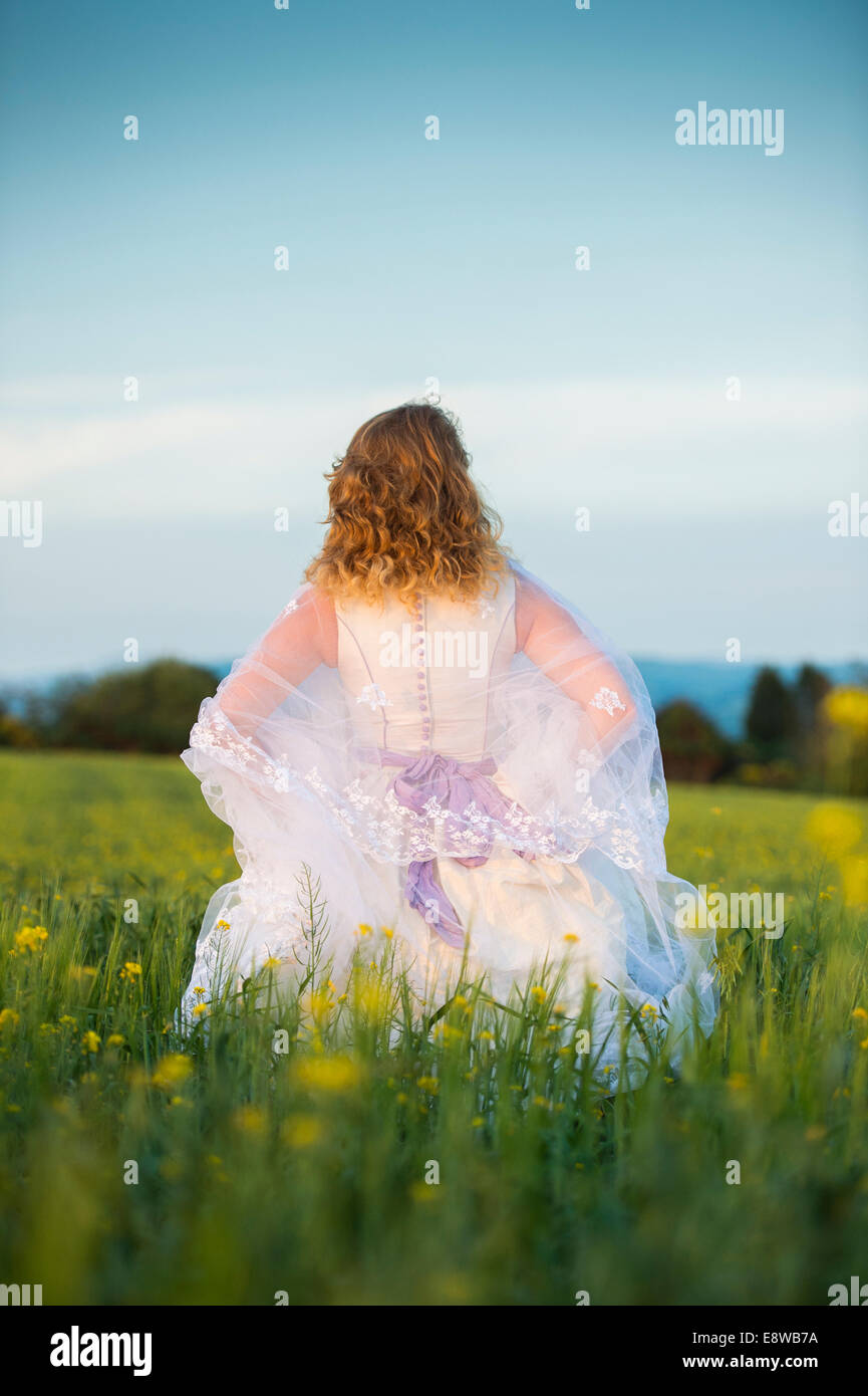 The runaway bride - a young woman girl in a wedding dress standing ...