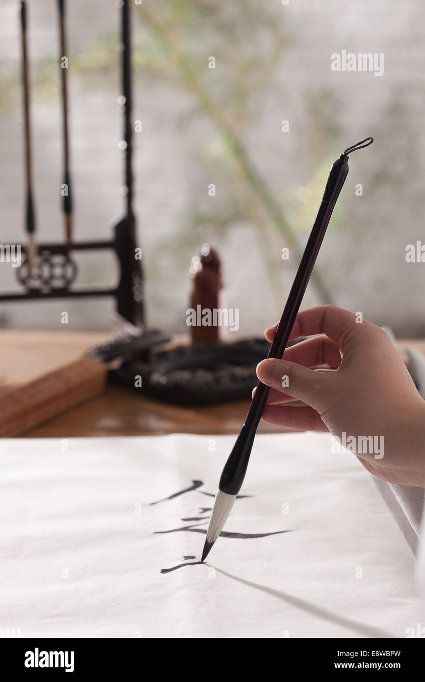 Hand write with a brush Stock Photo - Alamy