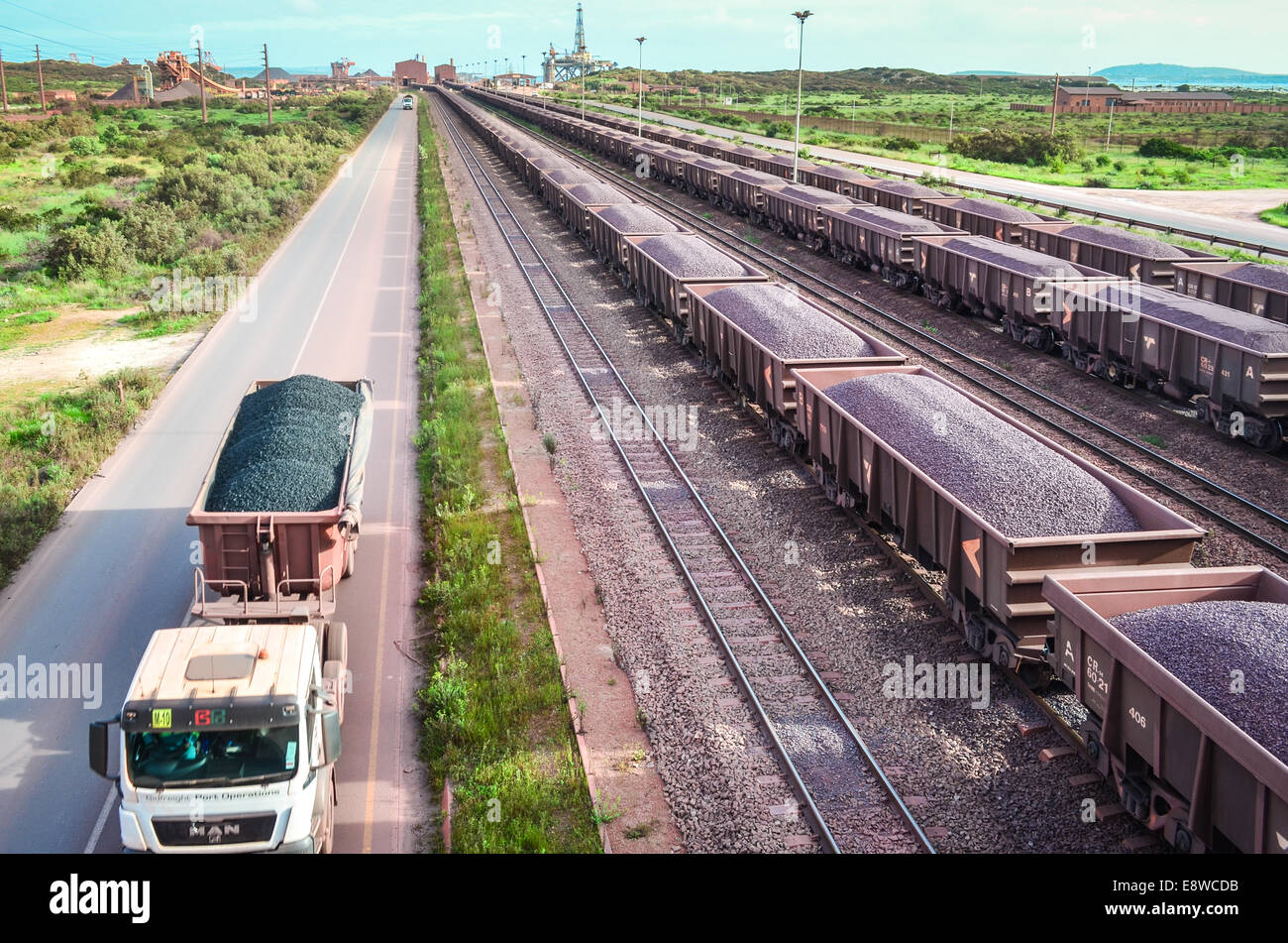 Iron ore wagons and trucks at the Saldanha terminal, South Africa. The ...