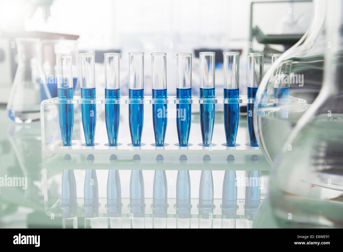 Rack of test tubes with solution on counter in lab Stock Photo - Alamy