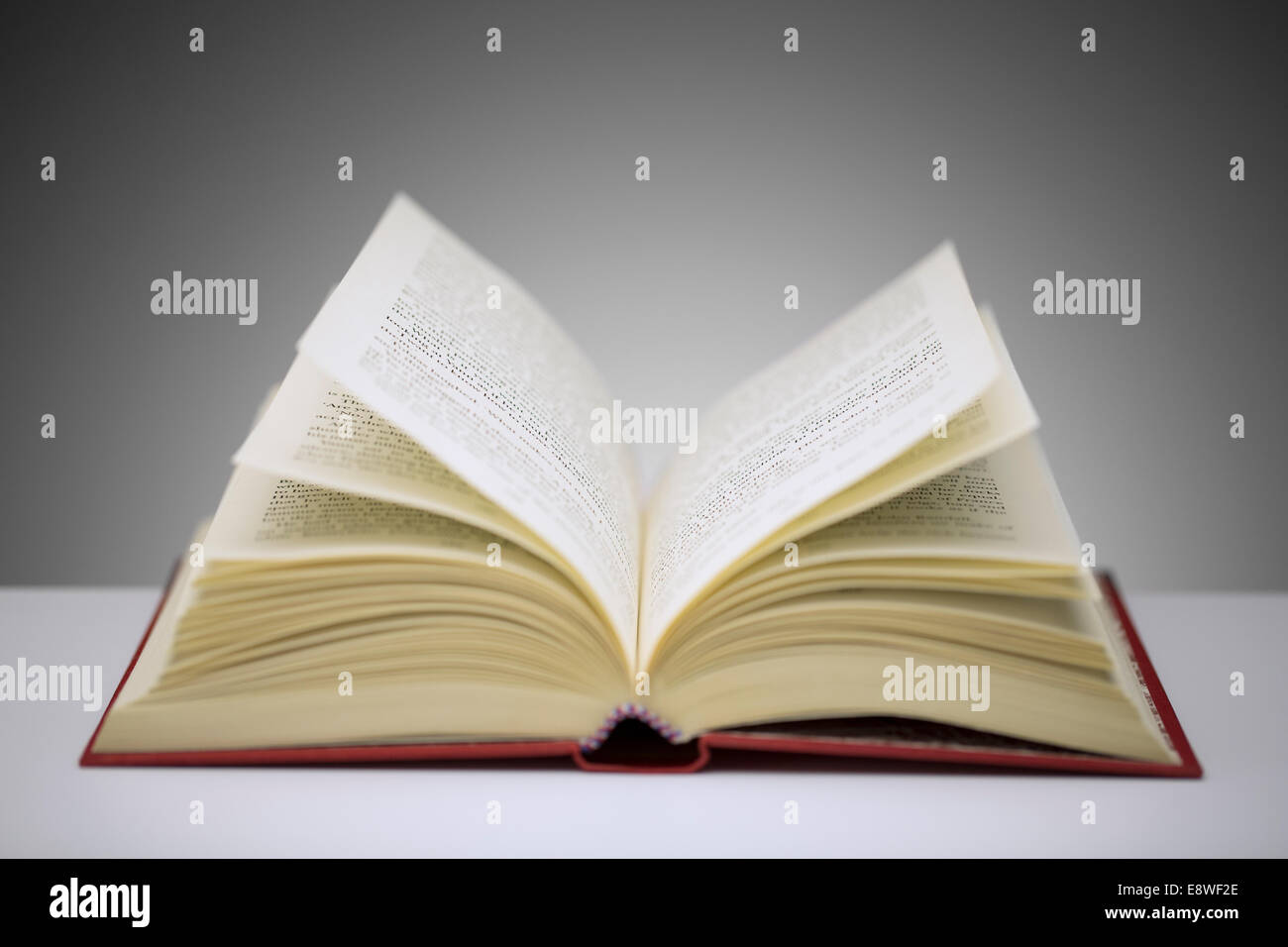 Close up of open book on counter Stock Photo - Alamy