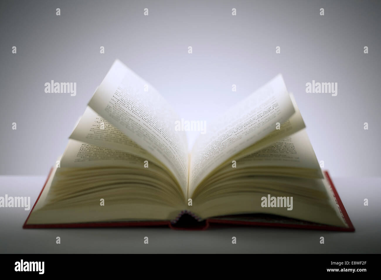 Close up of open book on counter Stock Photo - Alamy