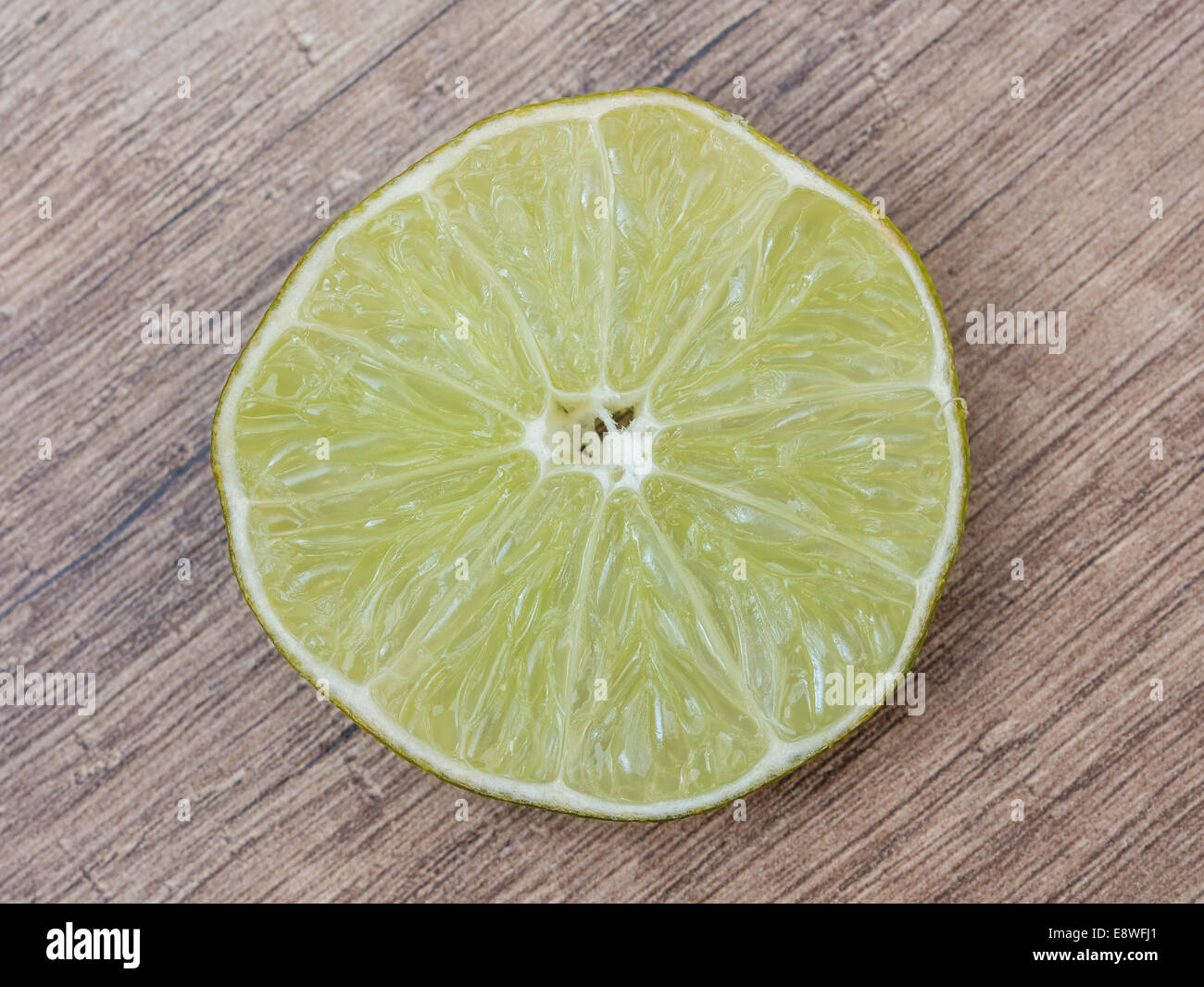 Lime Slice On Wood Table Stock Photo - Alamy