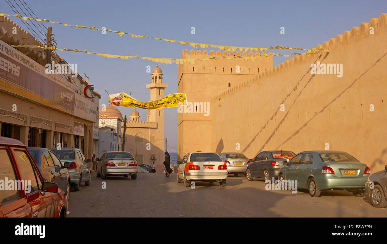 An Omani woman crosses a street in the market town of As Suwayq in the ...