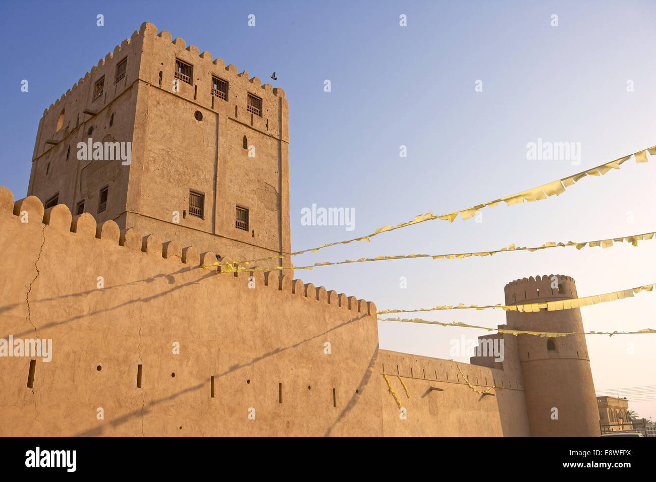 Festive bunting hanging from the castle in the market town of As Suwayq ...