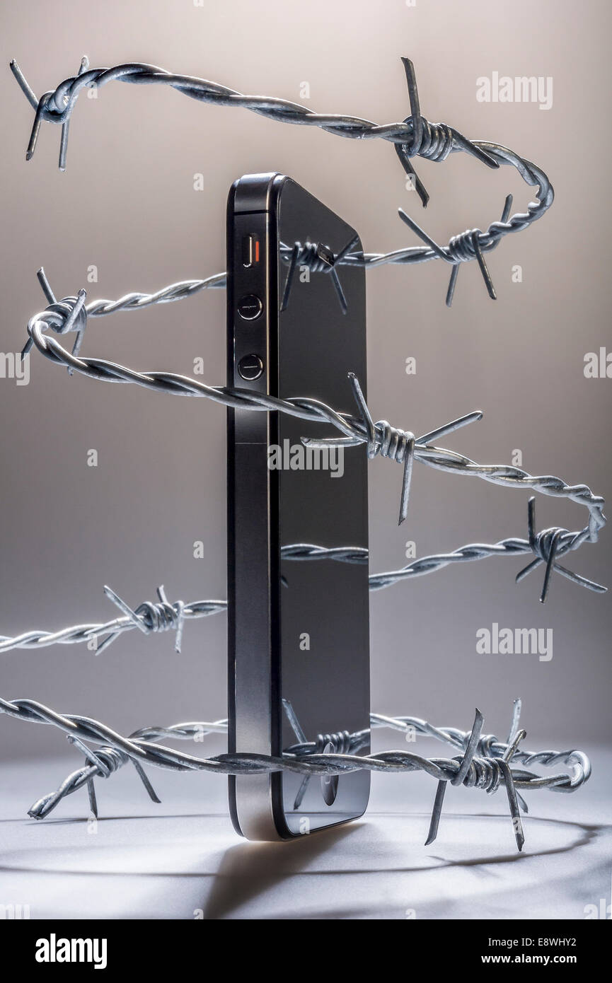 barbed wire with smart phone Stock Photo - Alamy