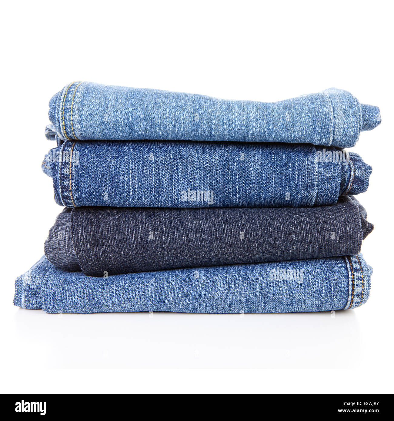 Pile of blue jeans over white background Stock Photo - Alamy