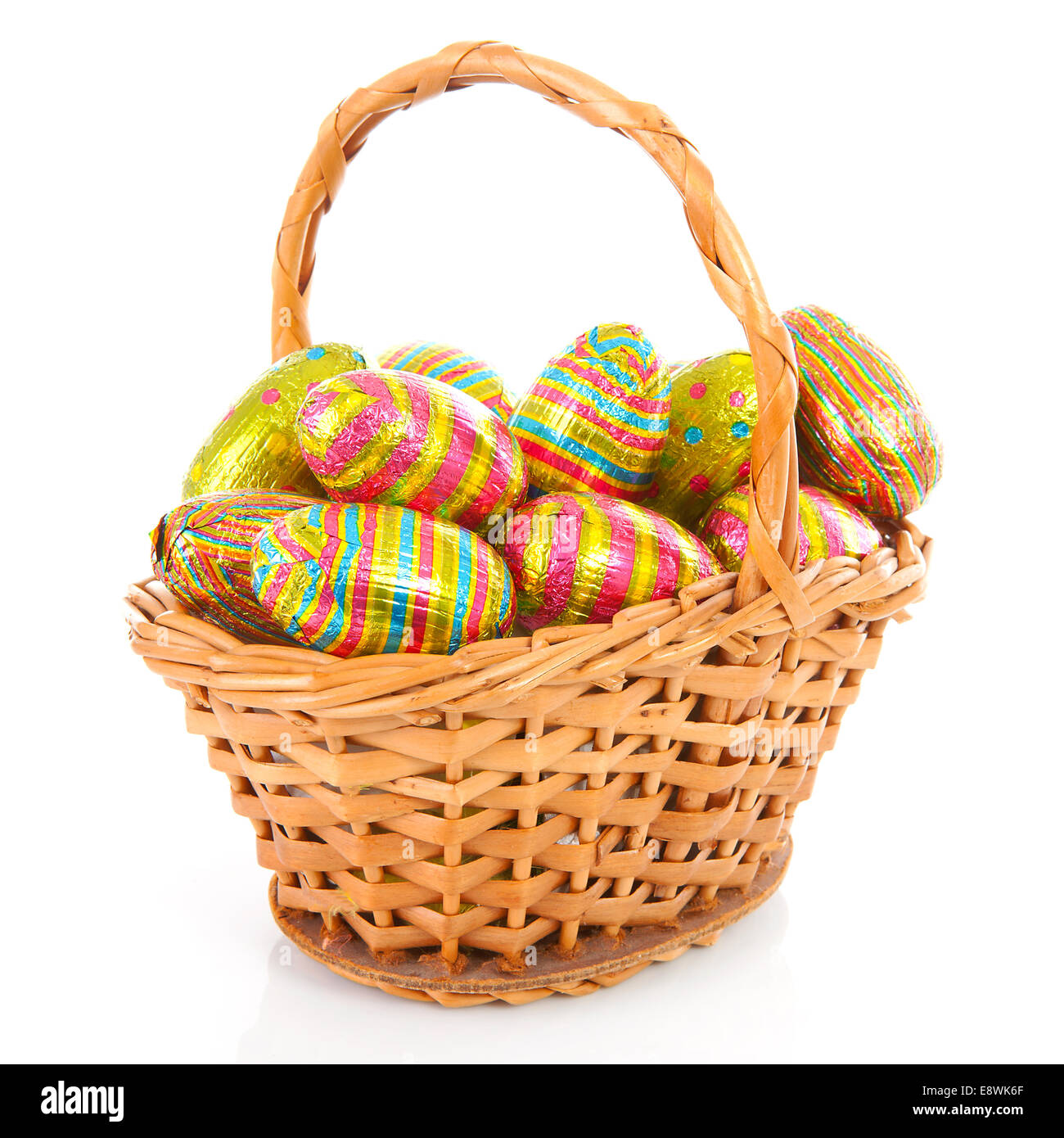 Cane basket with colorful easter eggs over white background Stock Photo ...
