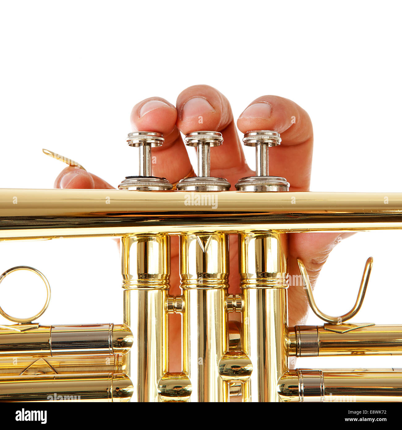 Close-up view of man's fingers as he plays trumpet over white ...