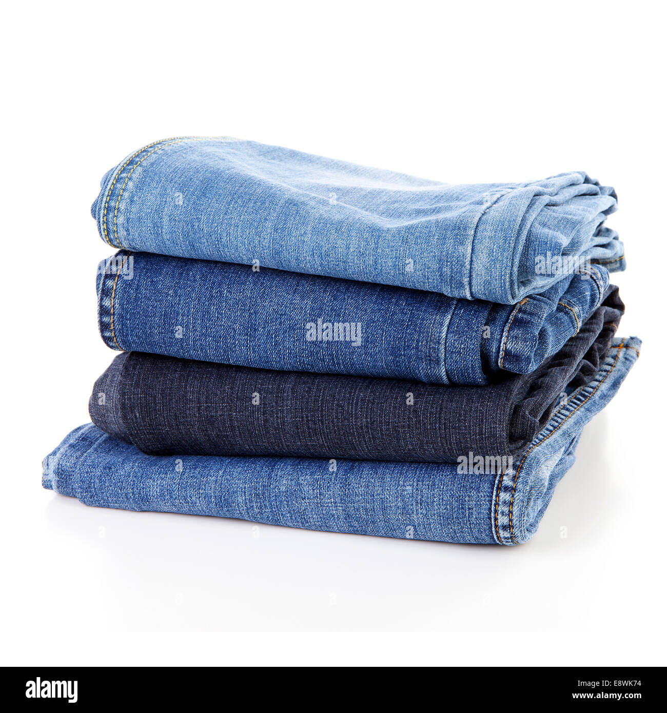 Pile of blue jeans over white background Stock Photo - Alamy