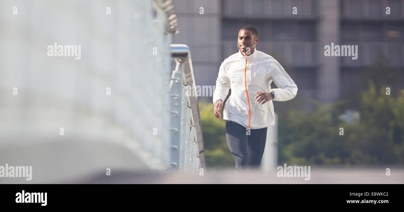 Man running through city streets Stock Photo - Alamy