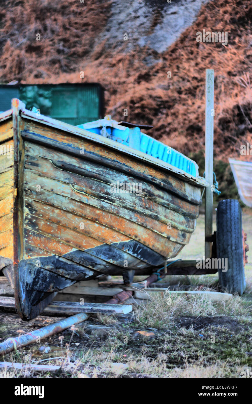 An old clinker built wooden working fishing boat on a trailer Stock ...