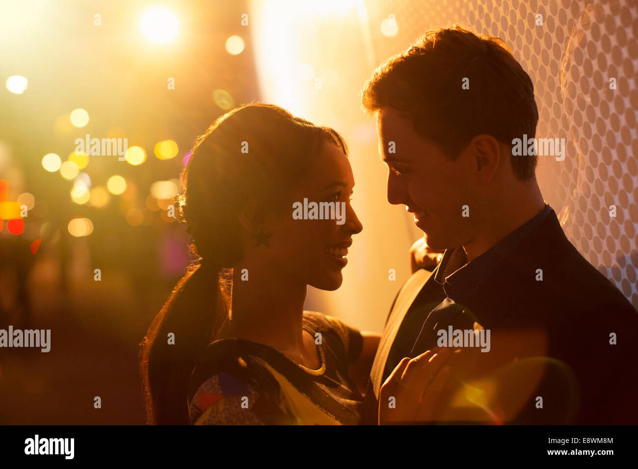 Couple hugging on city street at night Stock Photo - Alamy