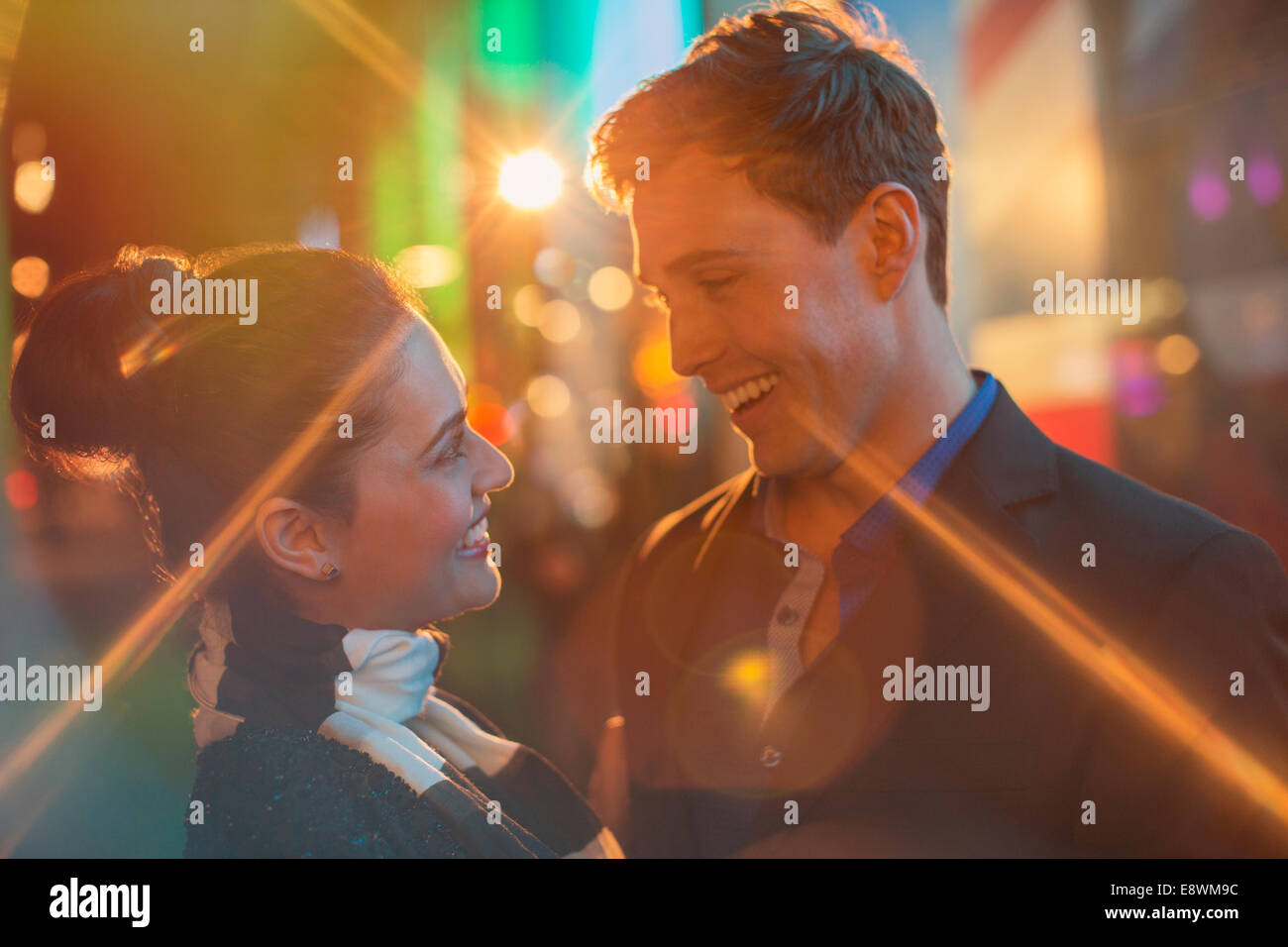Couple hugging on city street at night Stock Photo - Alamy
