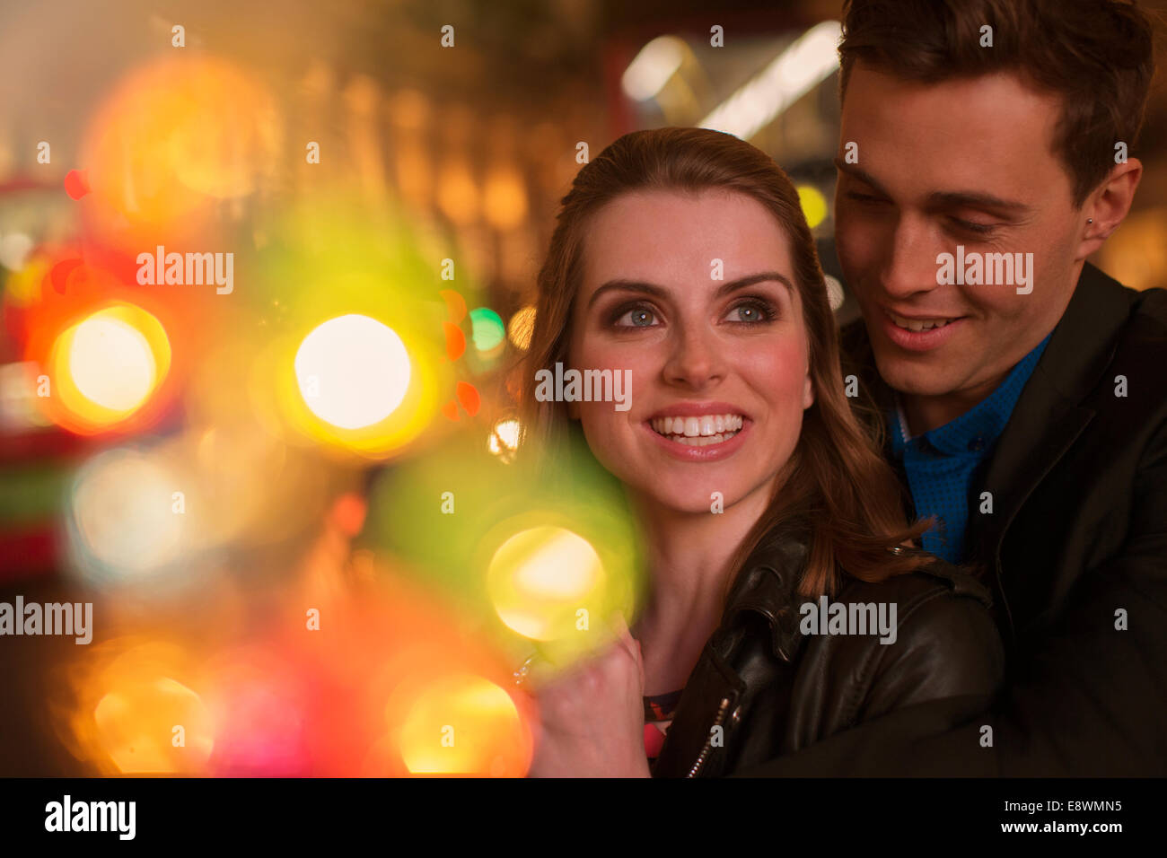 Couple hugging on city street at night Stock Photo - Alamy