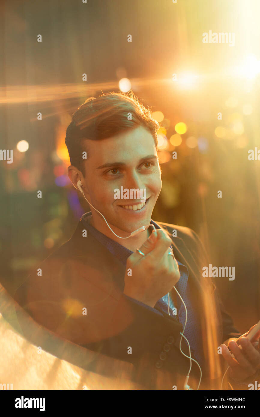 Man using headset while on phone call on city street Stock Photo - Alamy
