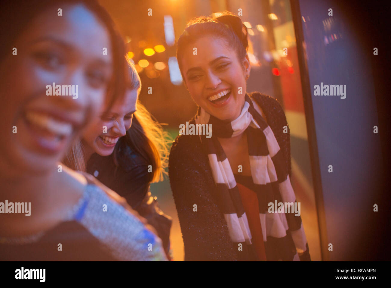 Friends playing on city street at night Stock Photo - Alamy