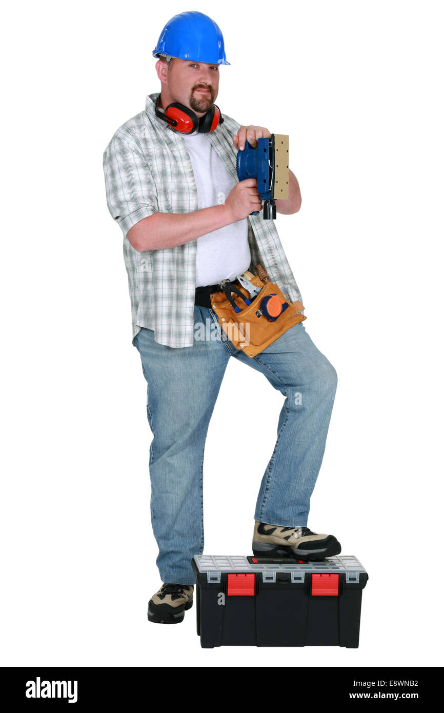 Man using power sander Stock Photo - Alamy