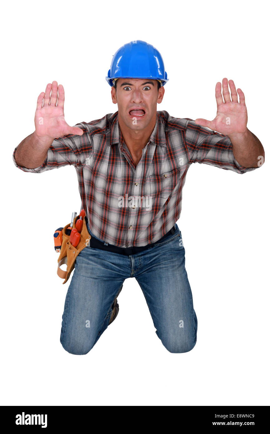 Scared construction worker with his hands up Stock Photo - Alamy