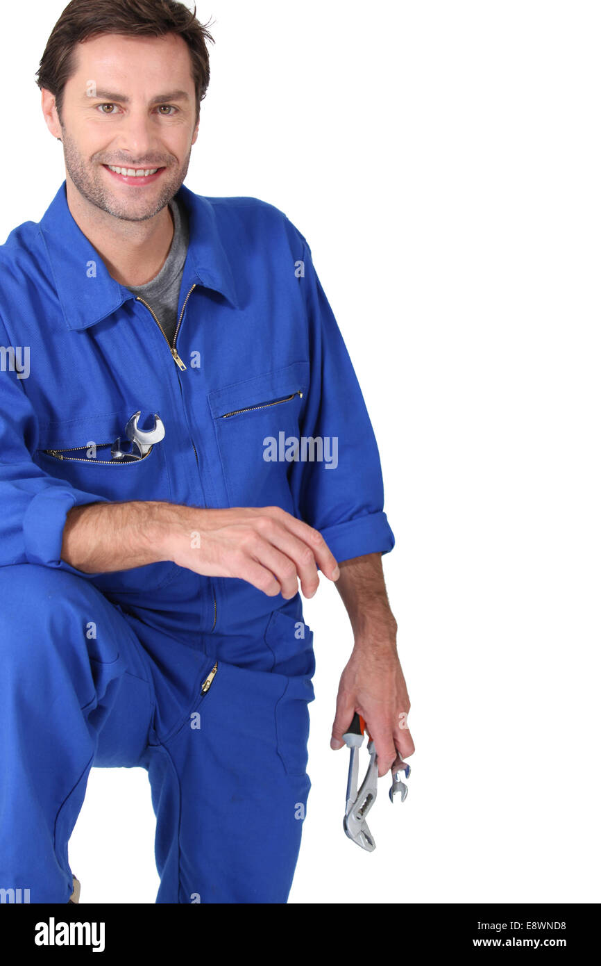 Artisan worker kneeling Stock Photo - Alamy
