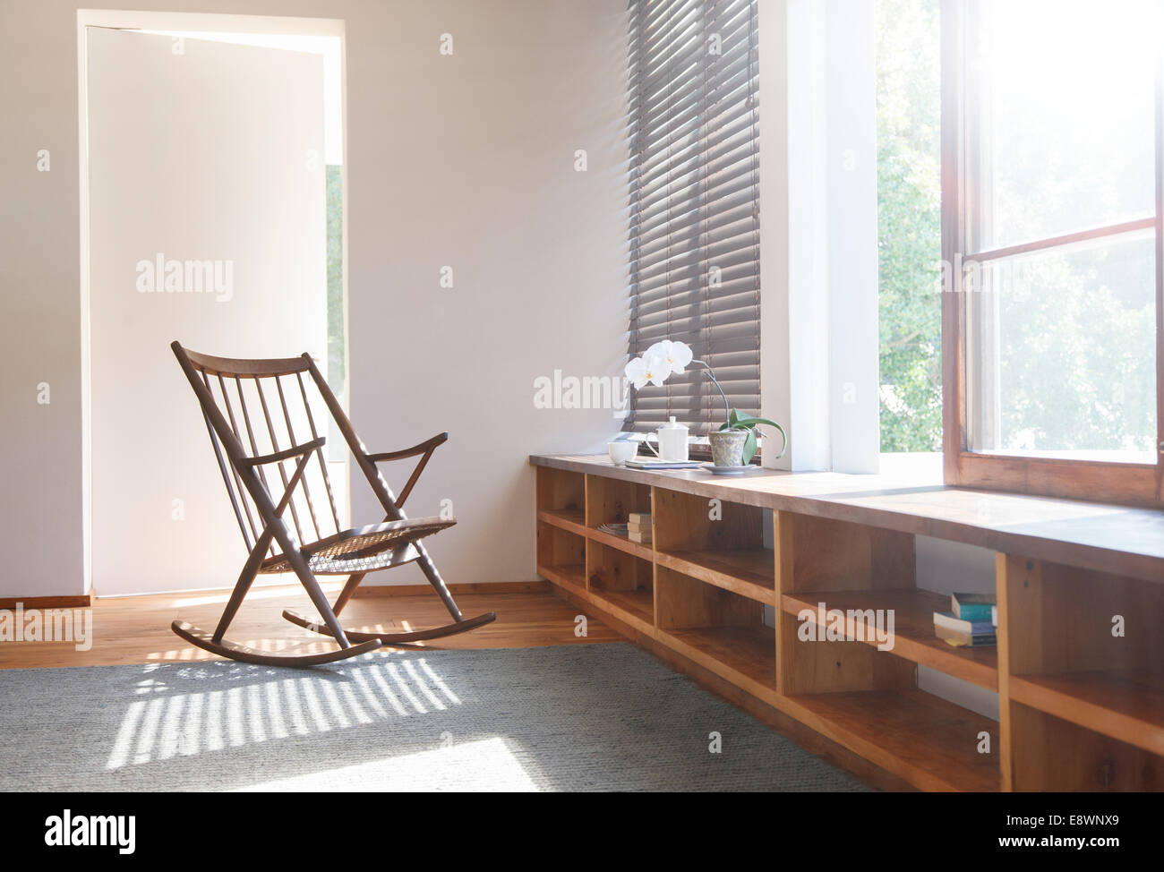 Rocking chair and rug in modern bedroom Stock Photo - Alamy