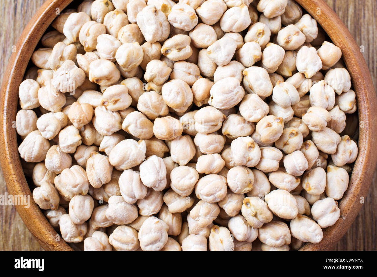 Dry chickpeas in a wooden bowl. Top view Stock Photo - Alamy