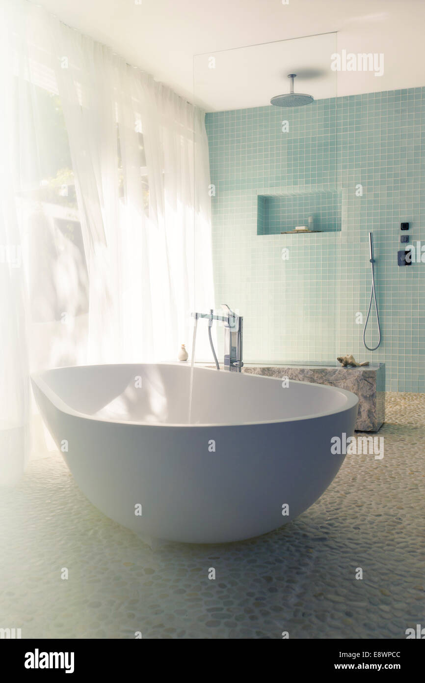 Water pouring into bathtub in modern bathroom Stock Photo - Alamy