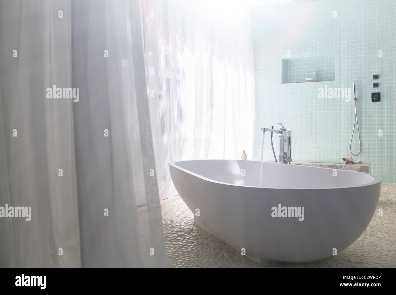 Water pouring into bathtub in modern bathroom Stock Photo - Alamy