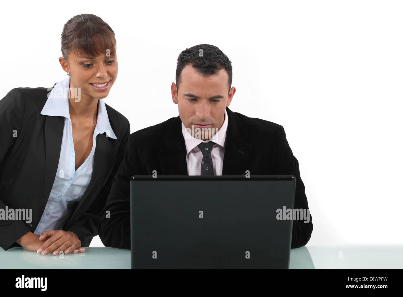 Happy woman peering over her colleague's shoulder Stock Photo - Alamy