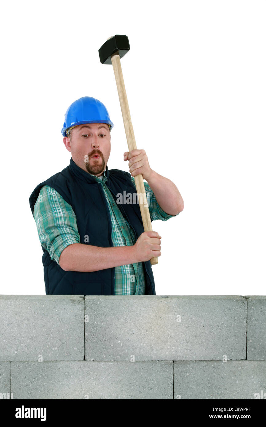 Builder about to smash wall Stock Photo - Alamy