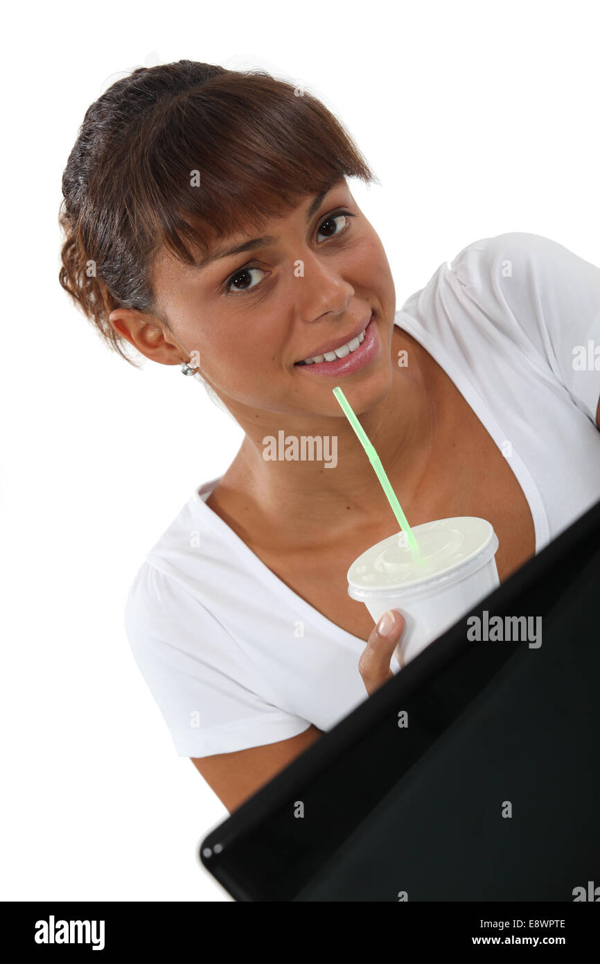 Woman with drink in front of computer Stock Photo - Alamy