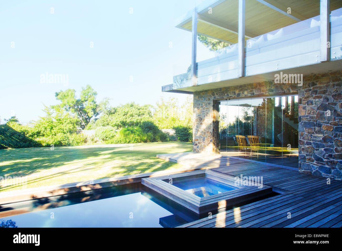 Modern house overlooking pool and wooden deck Stock Photo - Alamy