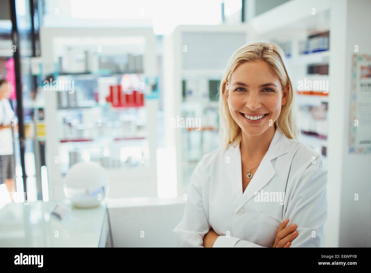 Pharmacist smiling in drugstore Stock Photo - Alamy