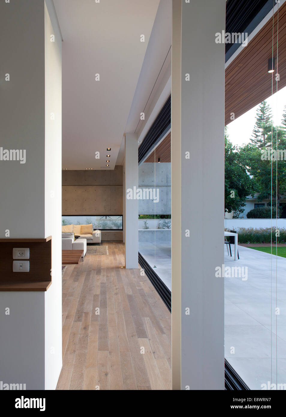 Open plan living area with view through windows to terrace of D House ...